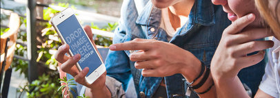 Placeit - iPhone Mockup of Two Friends Holding an iPhone 6