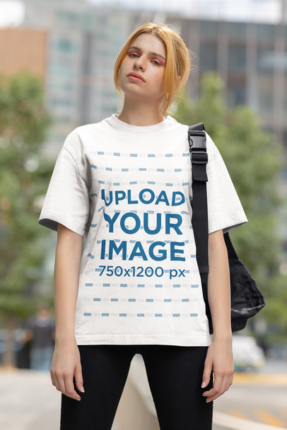 Placeit - Round-Neck Tee Mockup Featuring a Woman Posing by the Street
