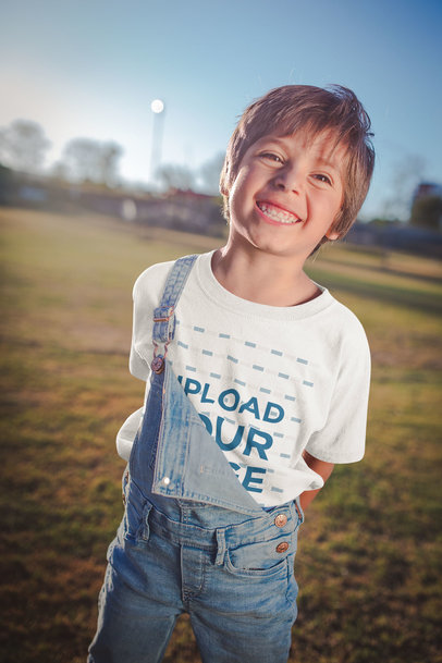 Placeit - Little Kid Wearing a T-Shirt Mockup at a Park
