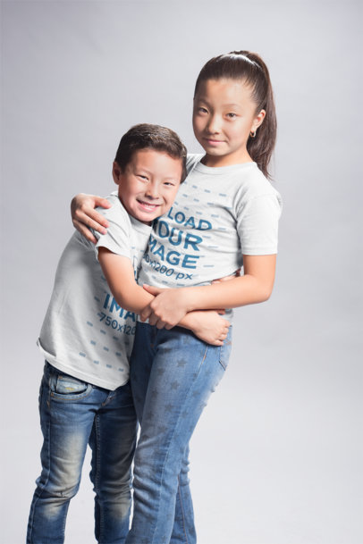 Placeit - Asian Kids Wearing Tshirts Mockup Hugging at a Photo Studio