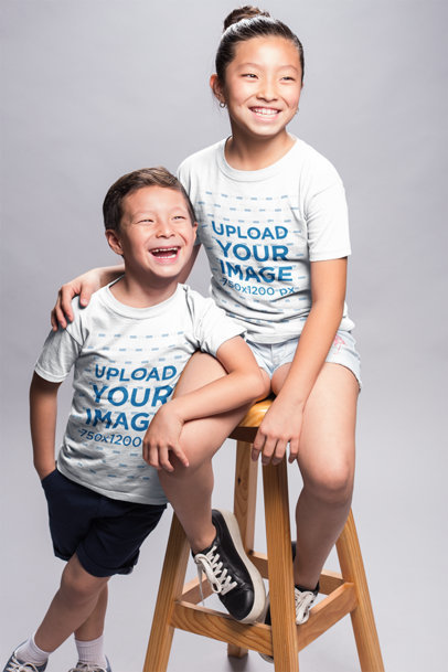 Placeit - Mockup of Smiling Kids Wearing T-Shirts in a Photo Studio