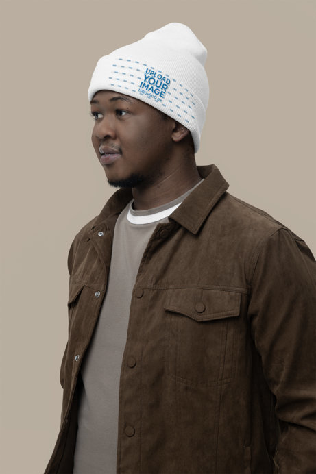 Placeit - Mockup of a Man Wearing a Yupoong Beanie in a Studio