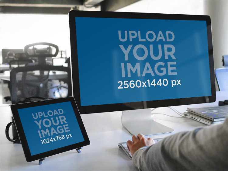 Placeit - Mockup of a Man Using an iMac and an iPad at an Office