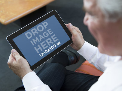 Placeit - Mockup of an Elderly Man Laying On a Sofa With a Samsung Tablet