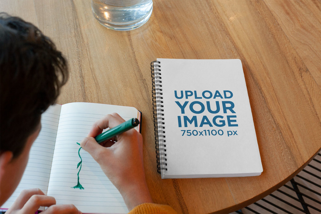 Placeit - School's Notebook Mockup Featuring a Boy Drawing