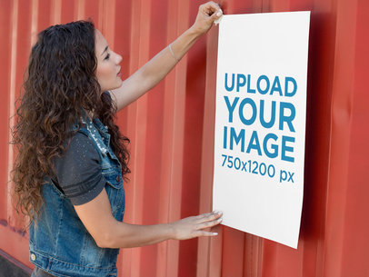 Placeit - Mockup Template of a Woman Taping a Poster to a Wall