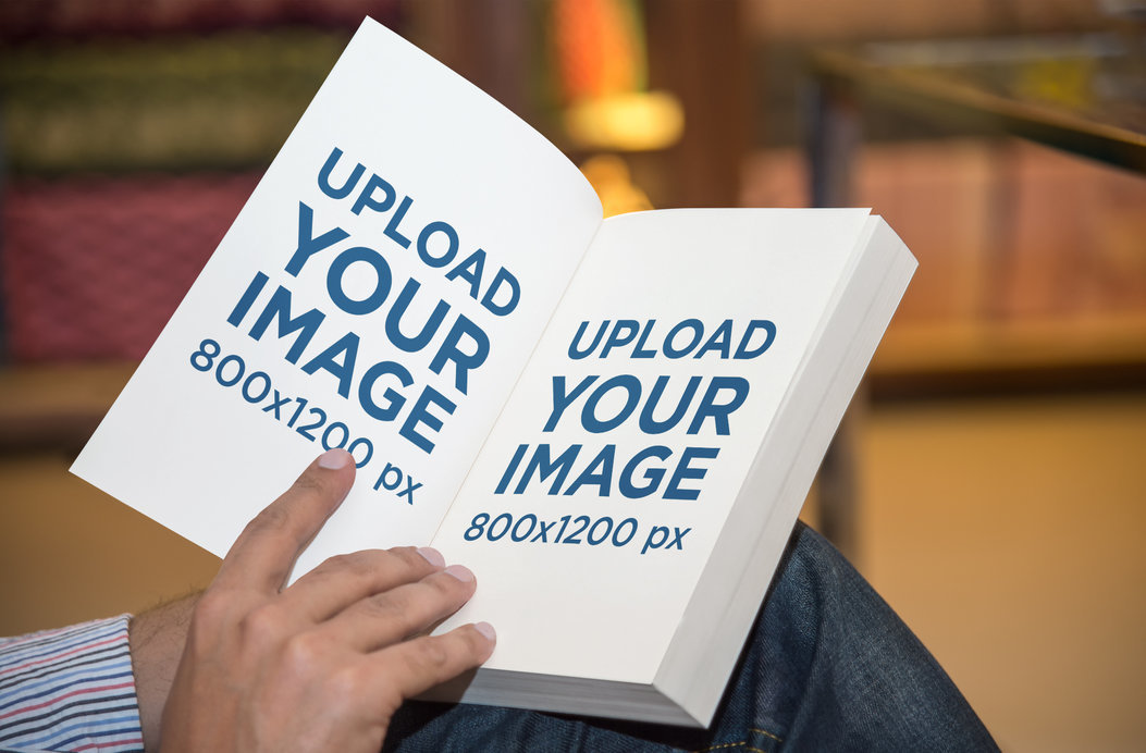 Placeit - Mockup of a Man Showing the First Interiors of a Digest Size Book