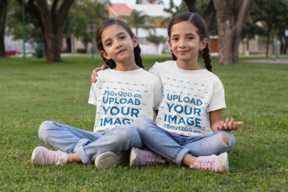 Placeit - T-Shirt Mockup of Two Identical Twin Girls at the Park
