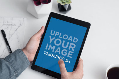 Placeit - Mockup of a Pair of Hands Holding an iPad in Portrait Position