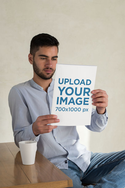 Placeit - Mockup Featuring a Young Man Holding a Magazine