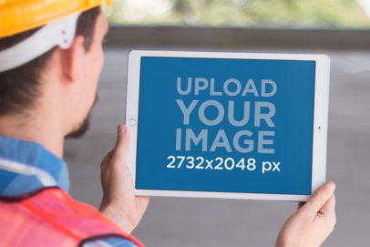 Placeit - Mockup of a Construction Worker Holding an iPad in Portrait ...