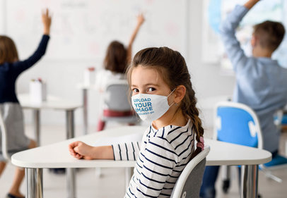 Placeit - Face Mask Mockup Featuring a Girl Raising Her Hand During Class
