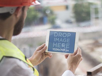 Placeit - Mockup of a Construction Worker Holding an iPad in Portrait ...