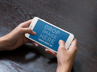Placeit - iPhone Mockup in Landscape Position of a Young Man Chilling